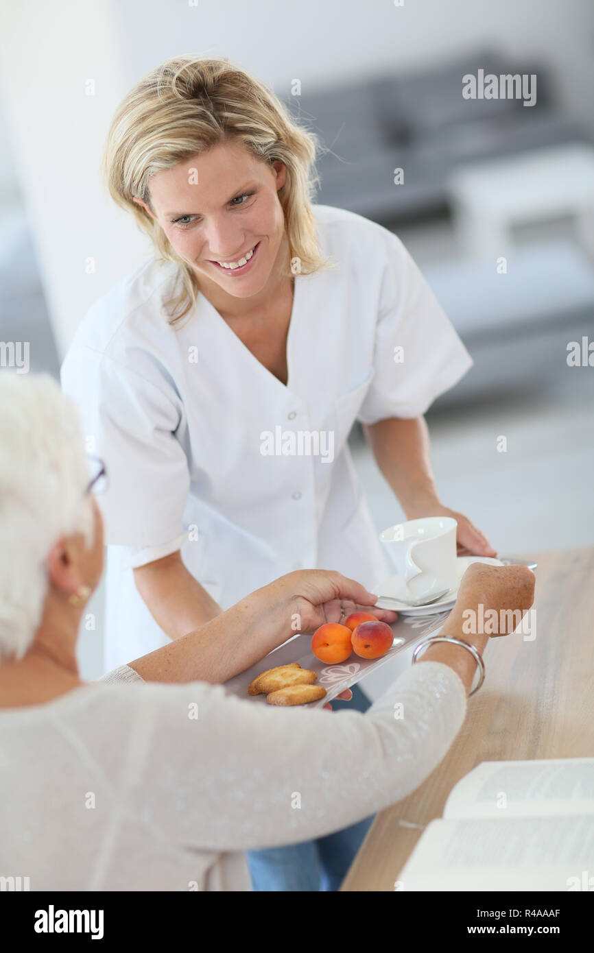 Woman giving tea older woman hi-res stock photography and images - Alamy