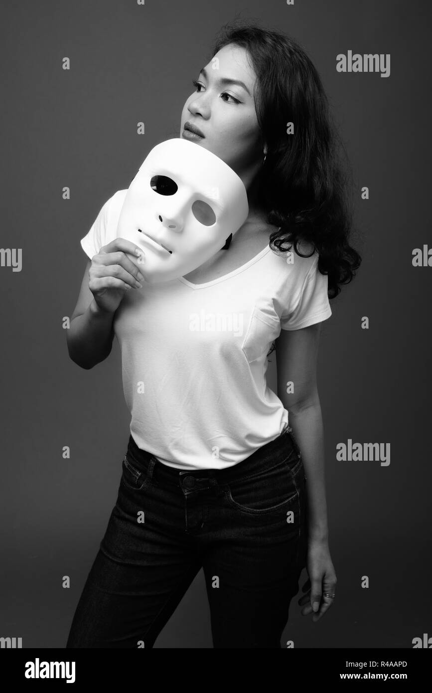 Portrait of young beautiful Asian woman holding mask Stock Photo - Alamy