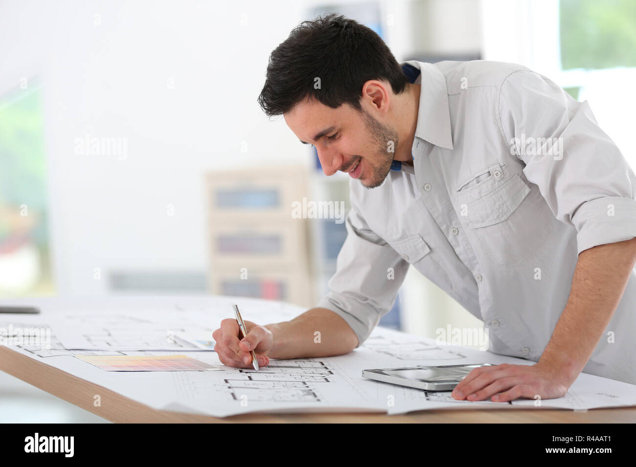 Architect in office drawing construction blueprint Stock Photo - Alamy