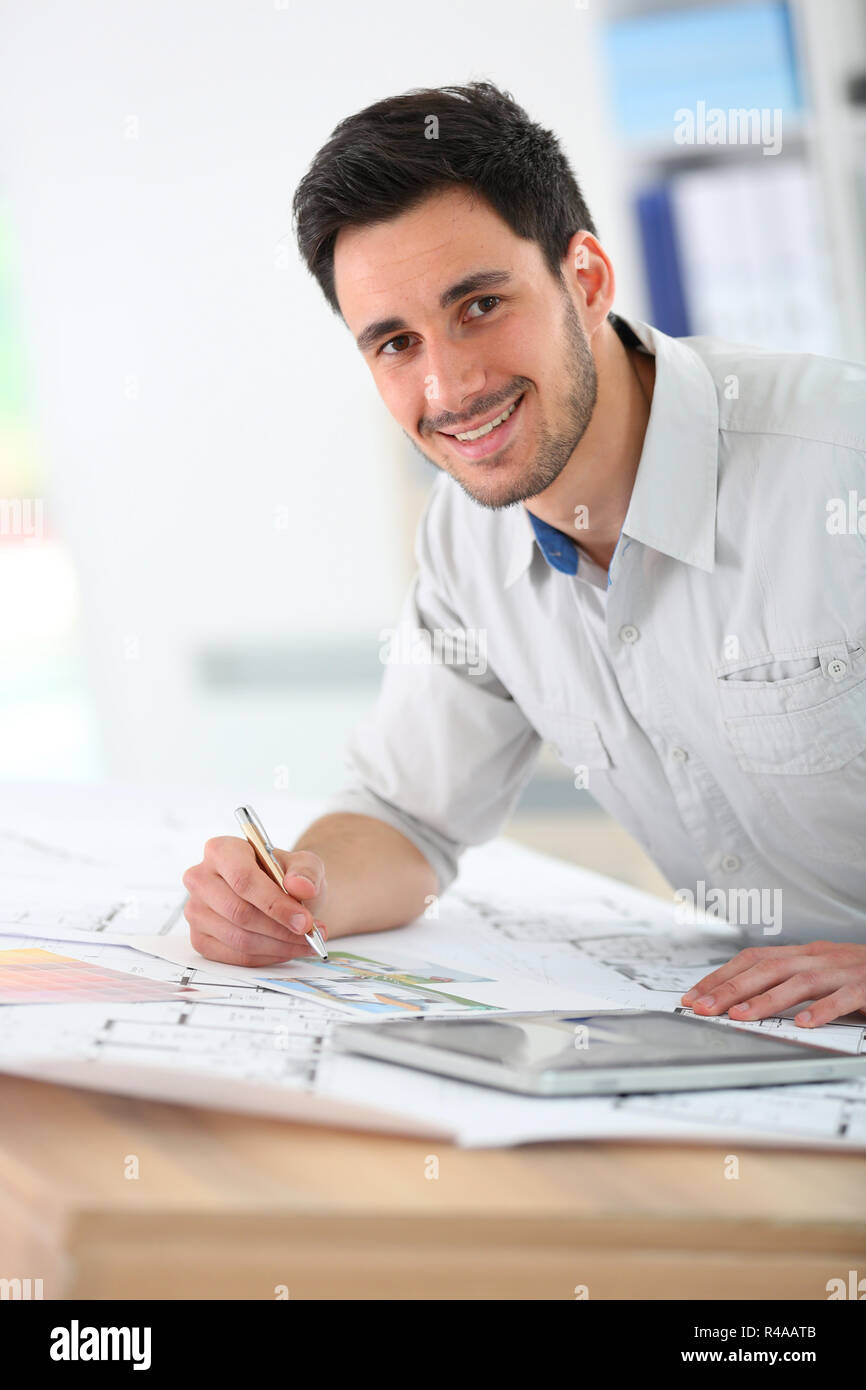 Architect in office drawing construction blueprint Stock Photo - Alamy