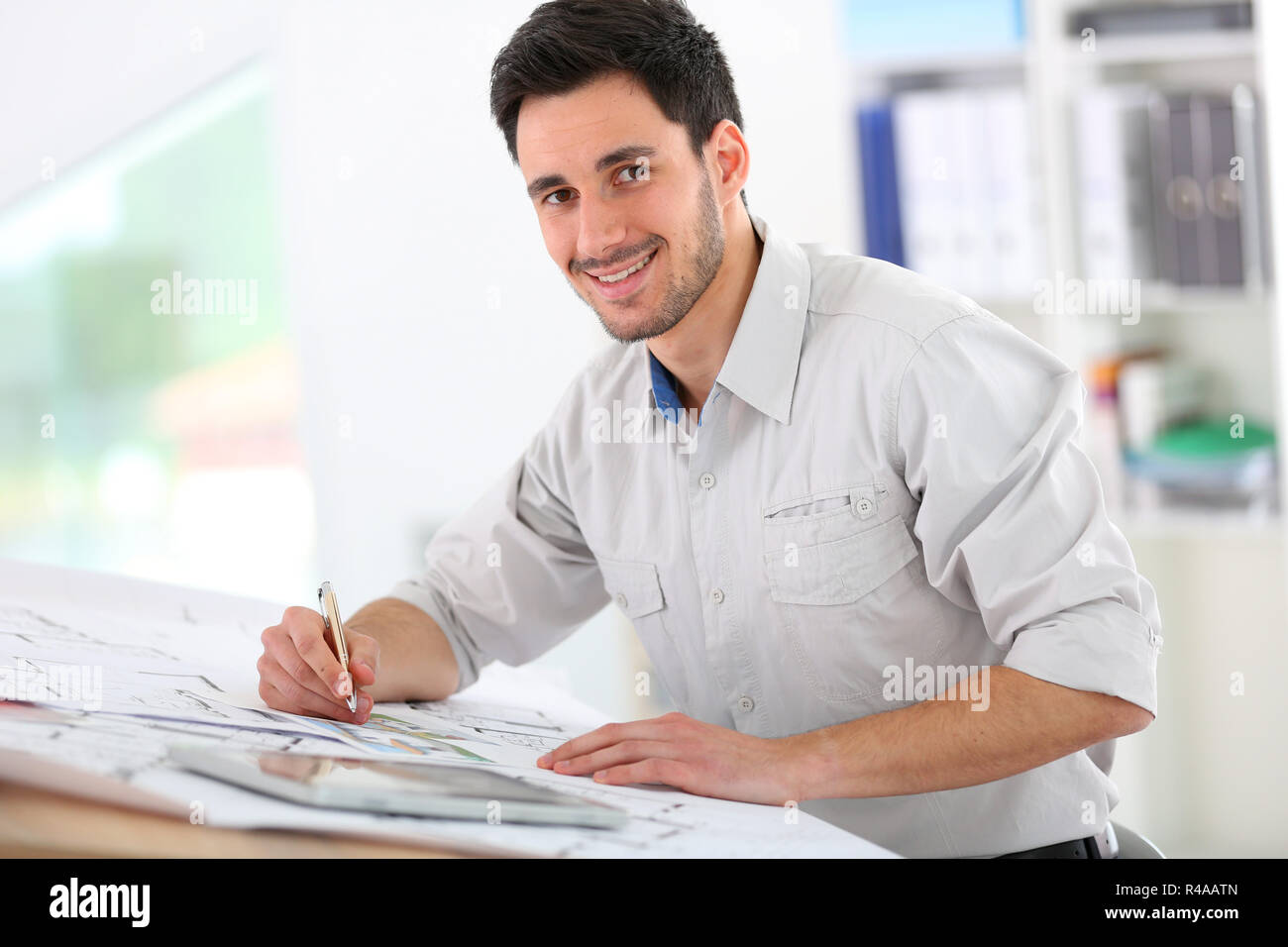 Architect in office drawing construction blueprint Stock Photo - Alamy