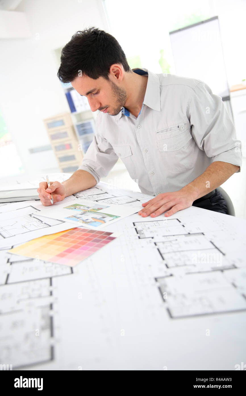 Architect in office drawing construction blueprint Stock Photo - Alamy