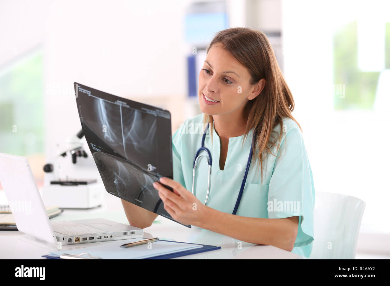 Nurse reading X-Ray results in hospital office Stock Photo - Alamy
