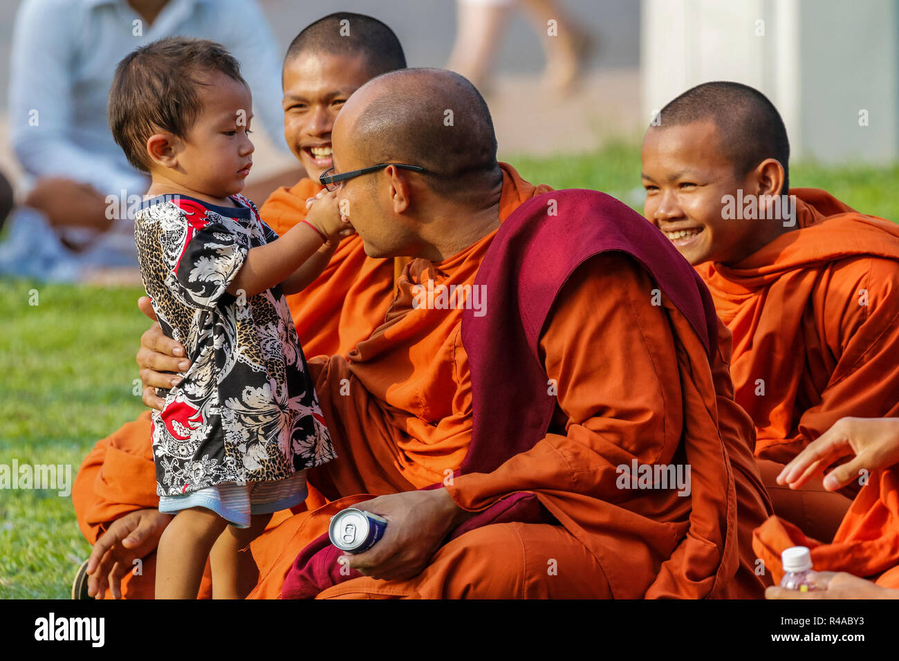 Buddhist monks with young child in the Royal Palace Park. Preah ...