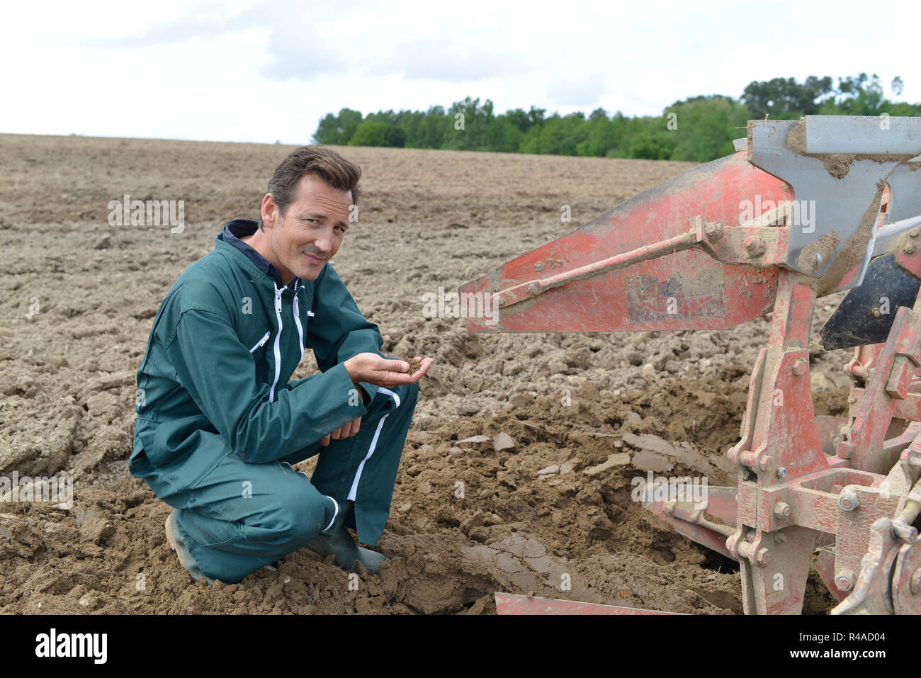 Farmer checking on cultivated ground quality Stock Photo - Alamy