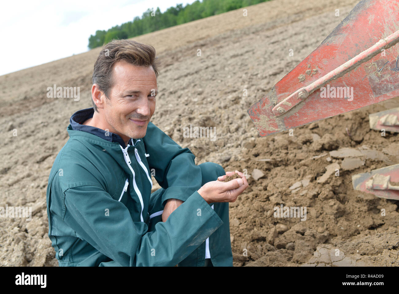 Farmer checking on cultivated ground quality Stock Photo - Alamy