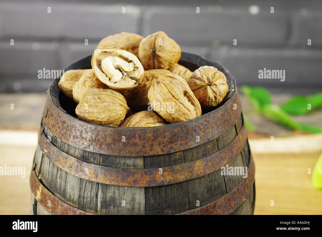 walnuts and walnut tree leaves in barrel Stock Photo - Alamy