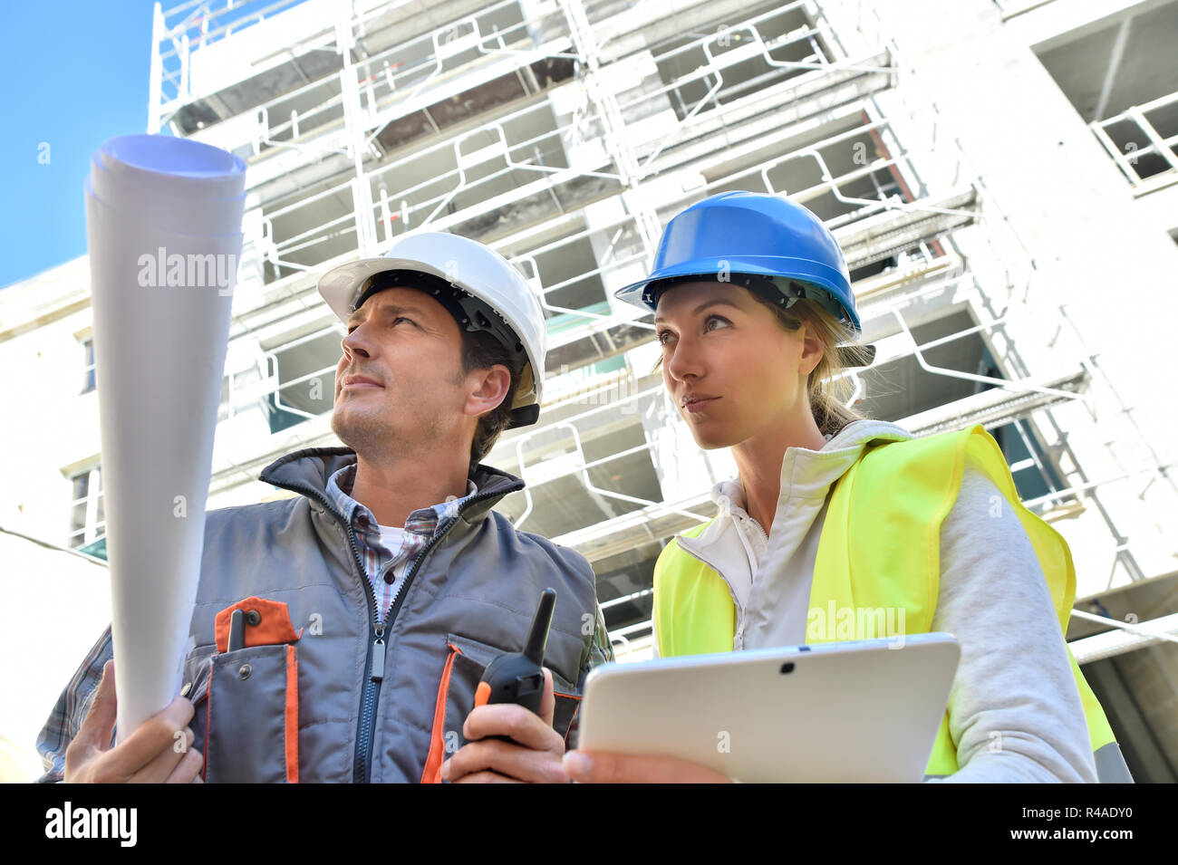 Construction team working on building site Stock Photo - Alamy