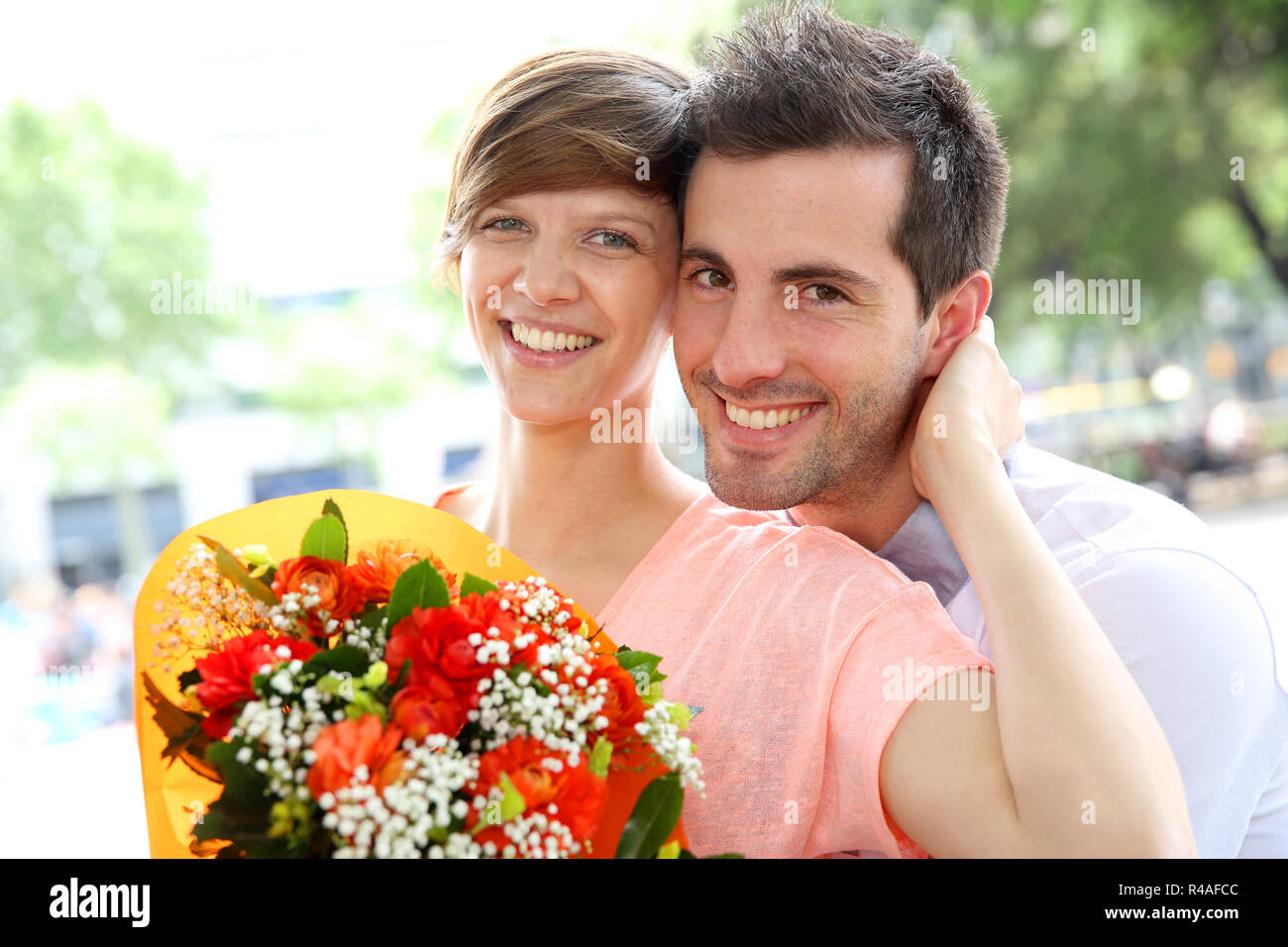 Girl receiving flowers from boyfriend Stock Photo - Alamy