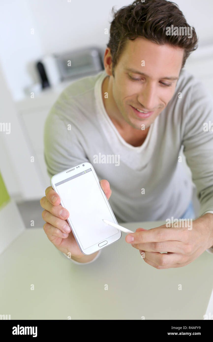 Man showing smartphone to camera Stock Photo - Alamy