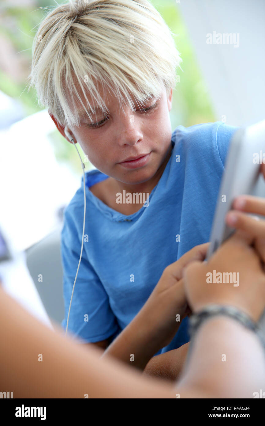 Teens listening to music with tablet Stock Photo - Alamy