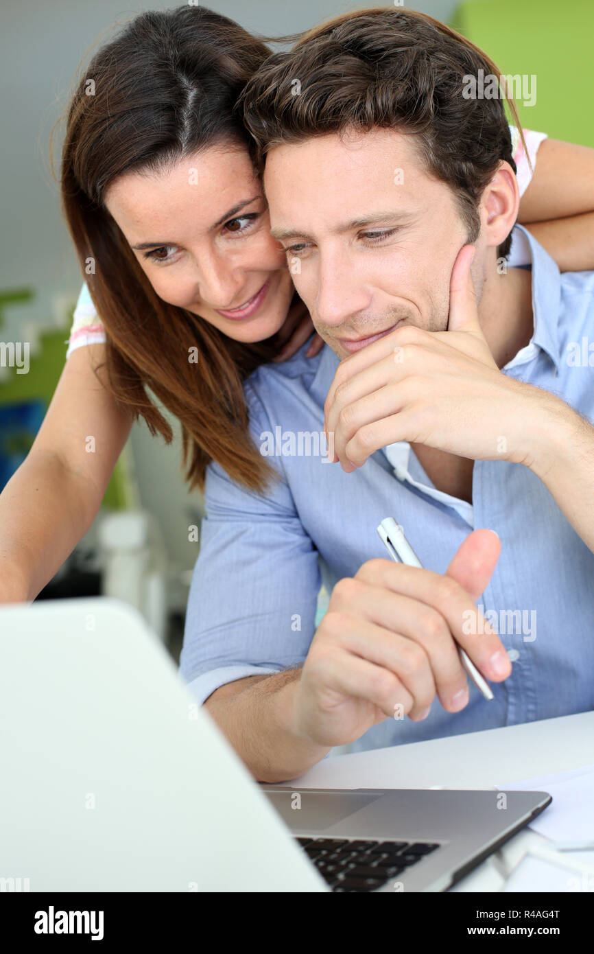 Couple at home looking at bank account on internet Stock Photo - Alamy