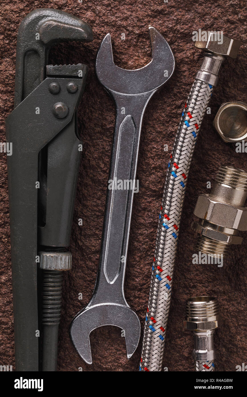 Set of tools for plumbing on a stone surface, top view Stock Photo - Alamy