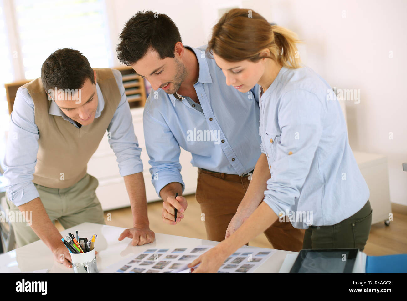 Creative team selecting image shots Stock Photo - Alamy