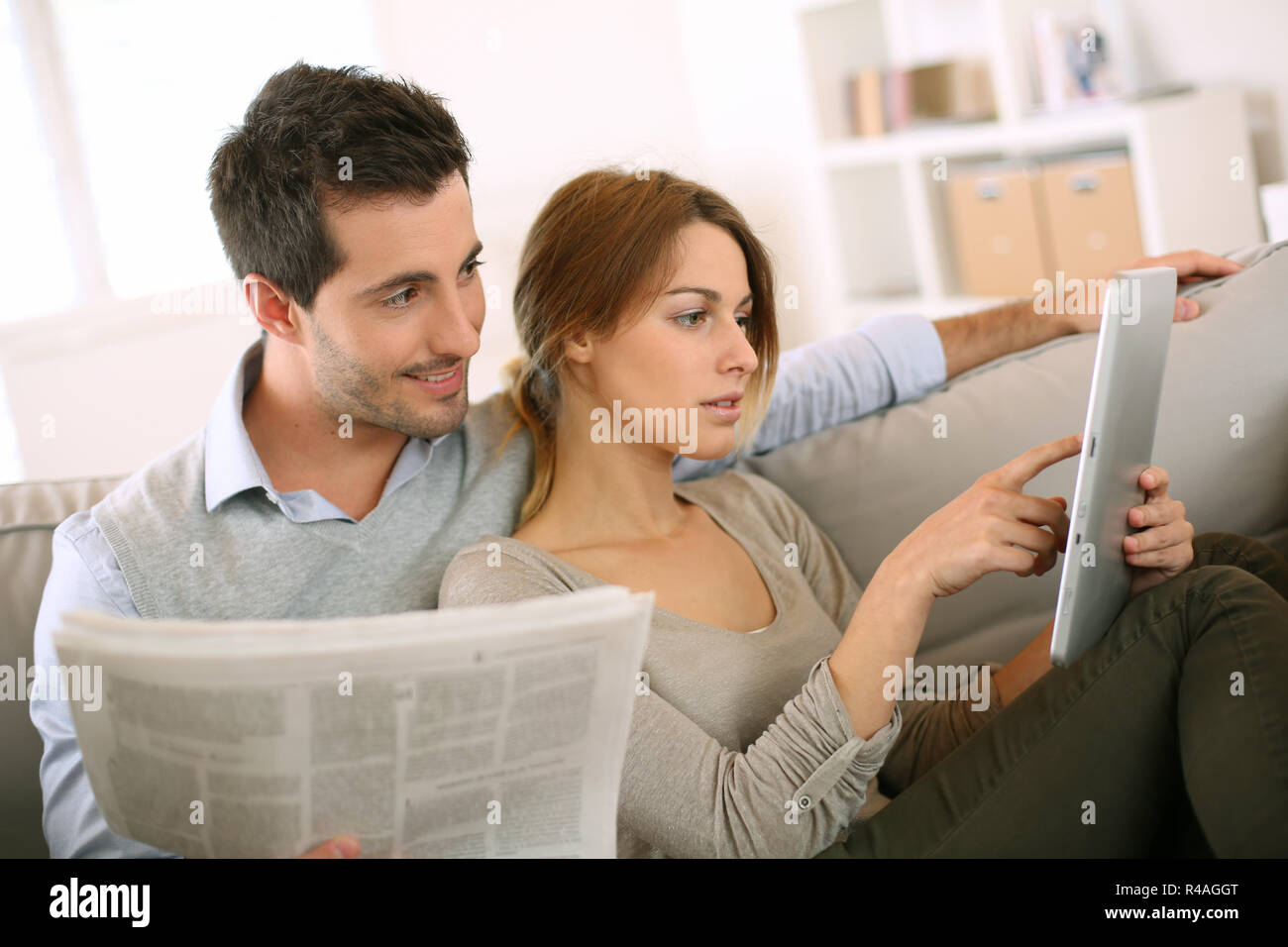 Couple reading news on both press and internet Stock Photo - Alamy
