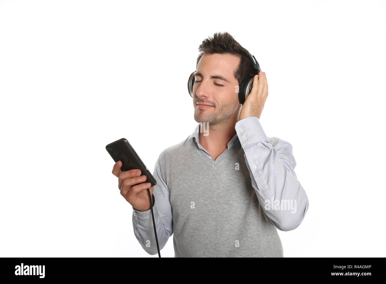 Man relaxing with headset and music player Stock Photo - Alamy