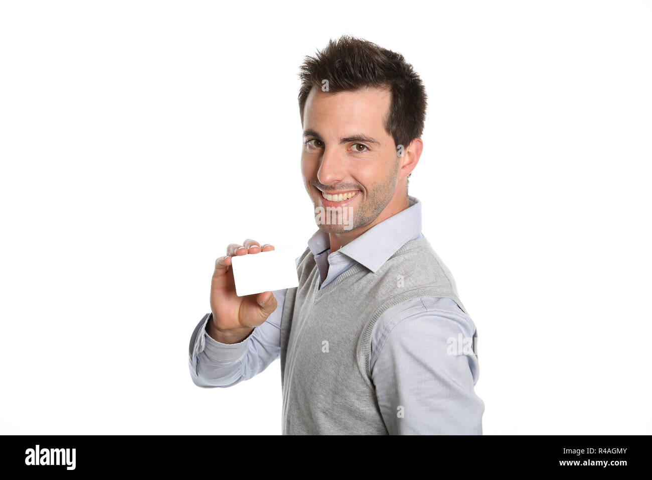 Handsome smiling man showing card Stock Photo - Alamy