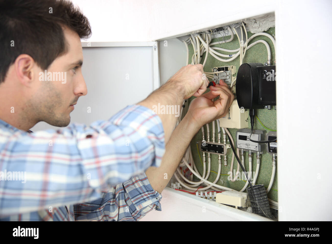 Electrician fixing cable in domestic electrical box Stock Photo - Alamy