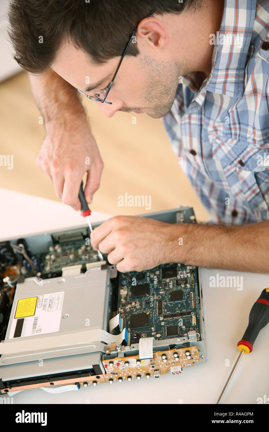 Man fixing electronic appliance Stock Photo - Alamy