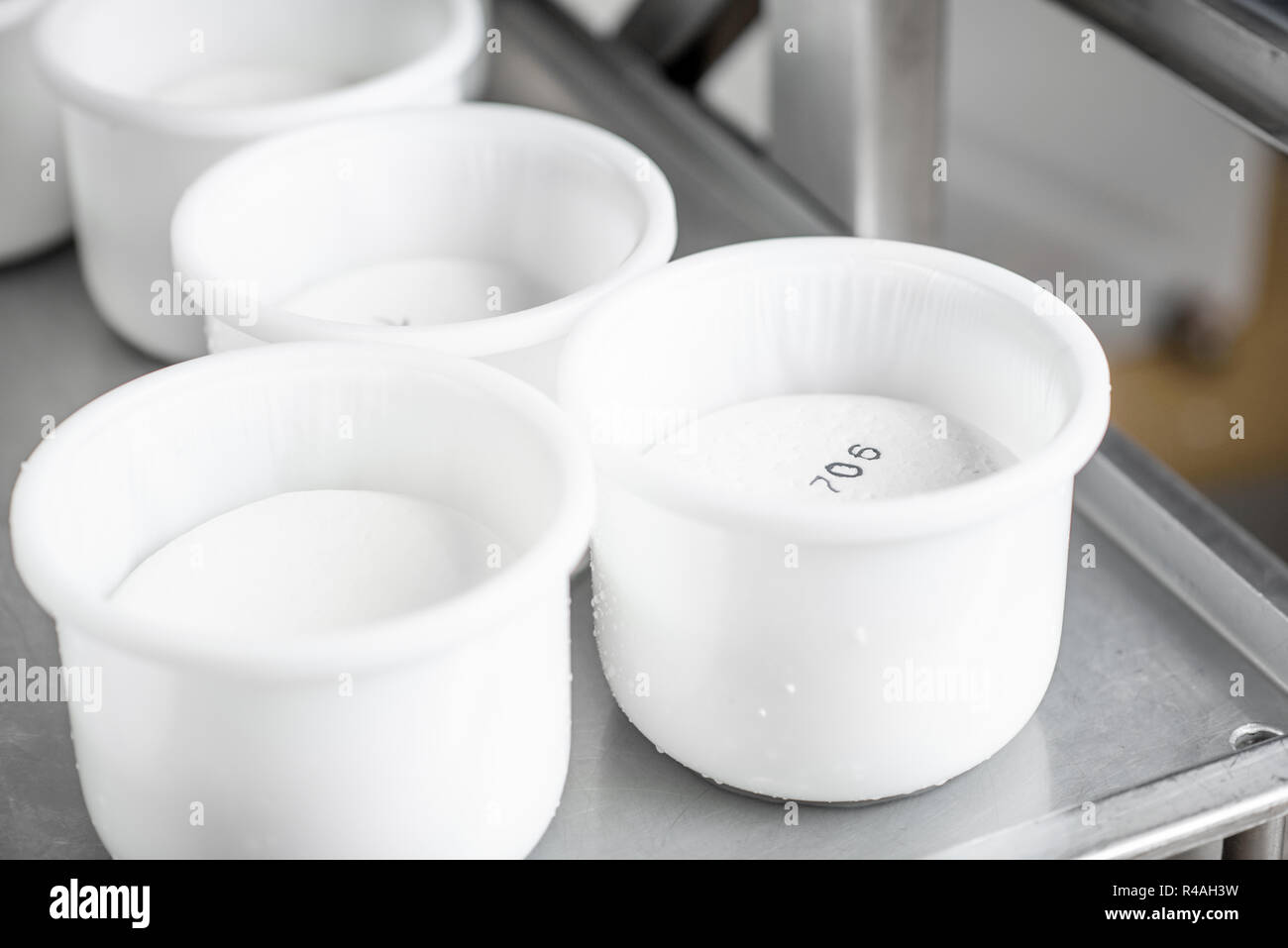 White plastic molds with fresh cheese ready for pressing at the cheese ...