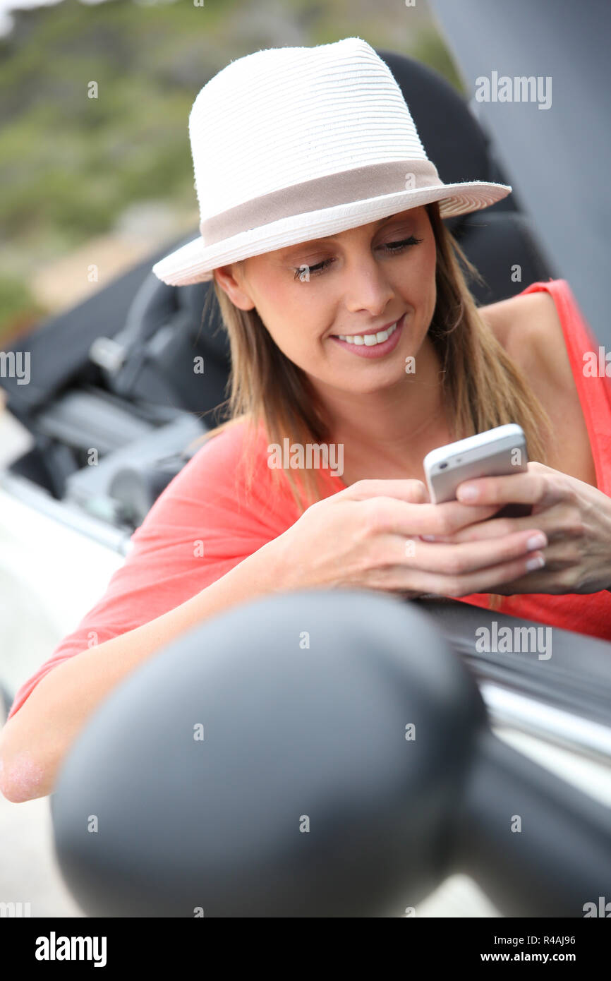 Using smartphone in her convertible hi-res stock photography and images ...