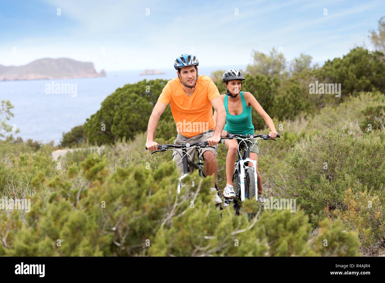 People biking bikes couple bikers riding bike ride cycle hi-res stock ...