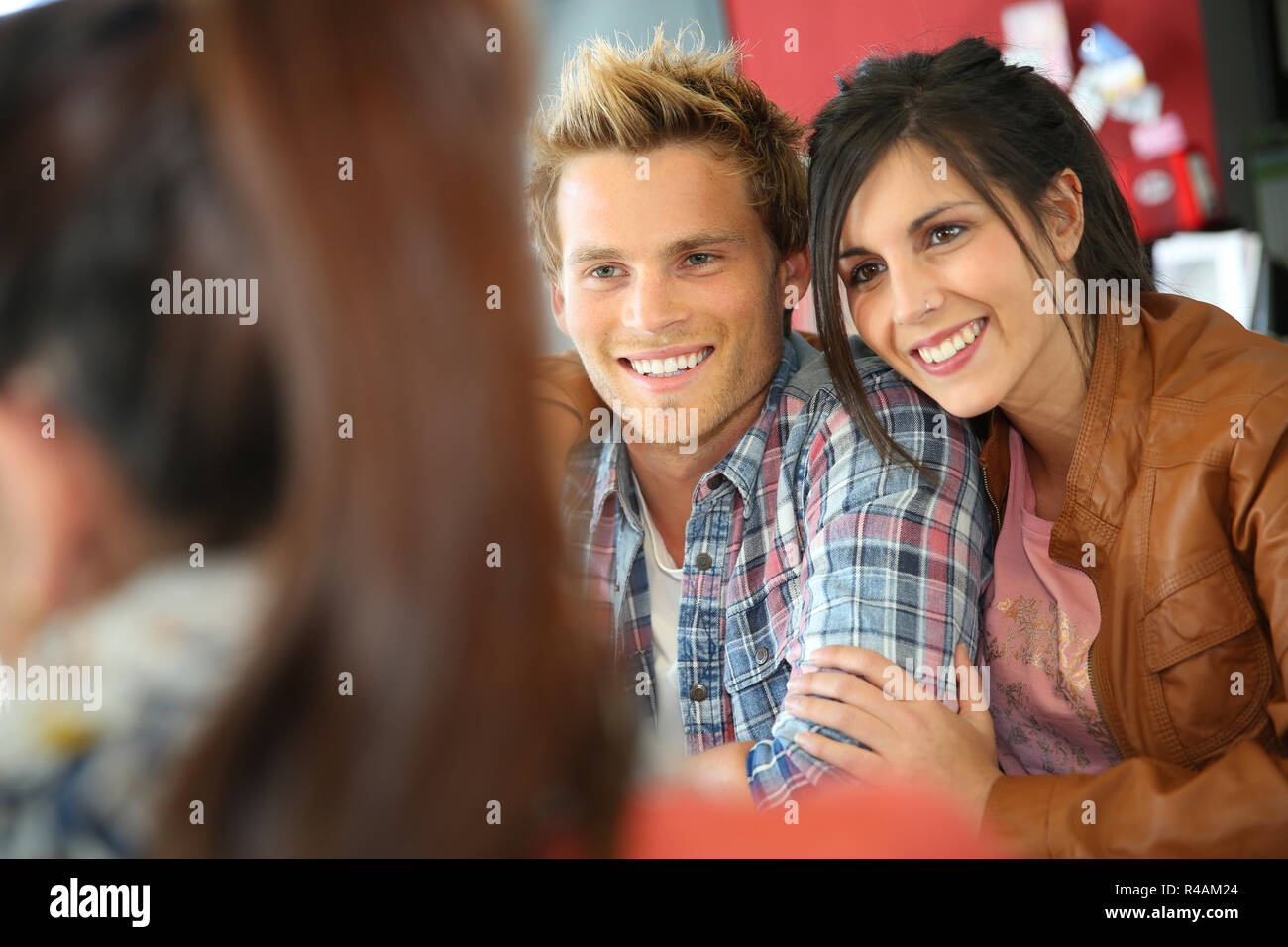 Couple gathering with friends at lunch time Stock Photo - Alamy