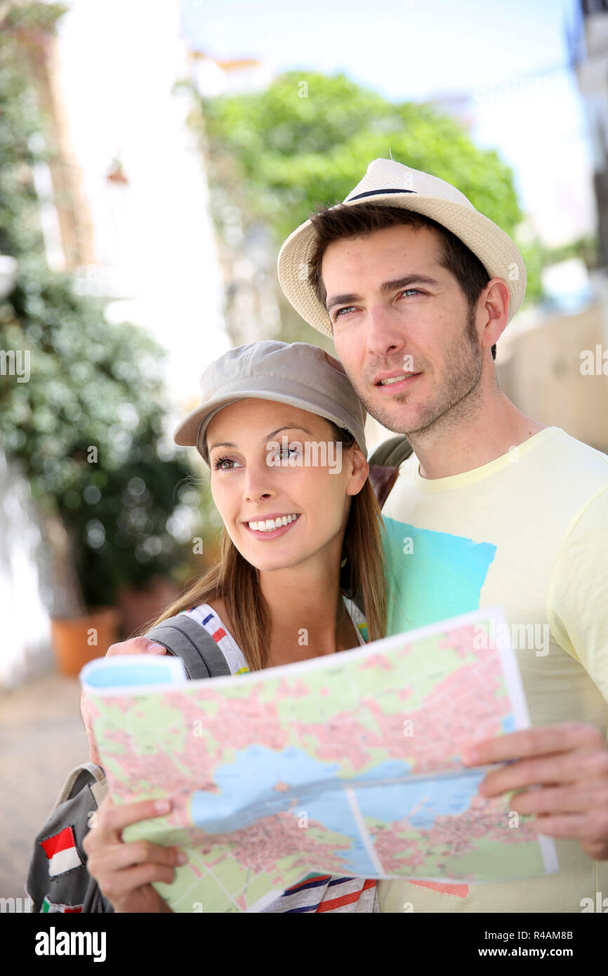 Couple of tourists in the street reading city map Stock Photo - Alamy