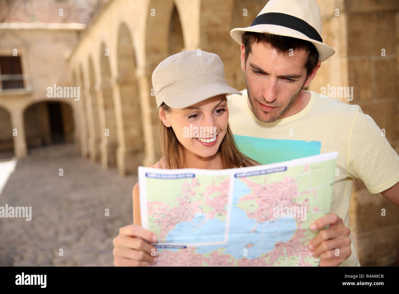 Couple of tourists looking at map Stock Photo - Alamy