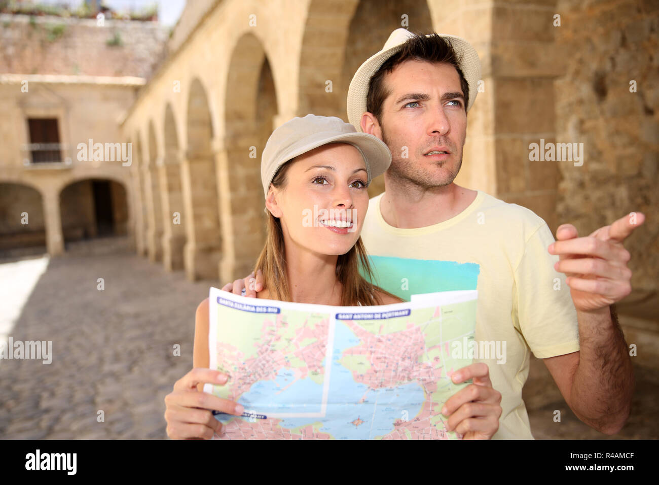 Couple of tourists looking at map Stock Photo - Alamy