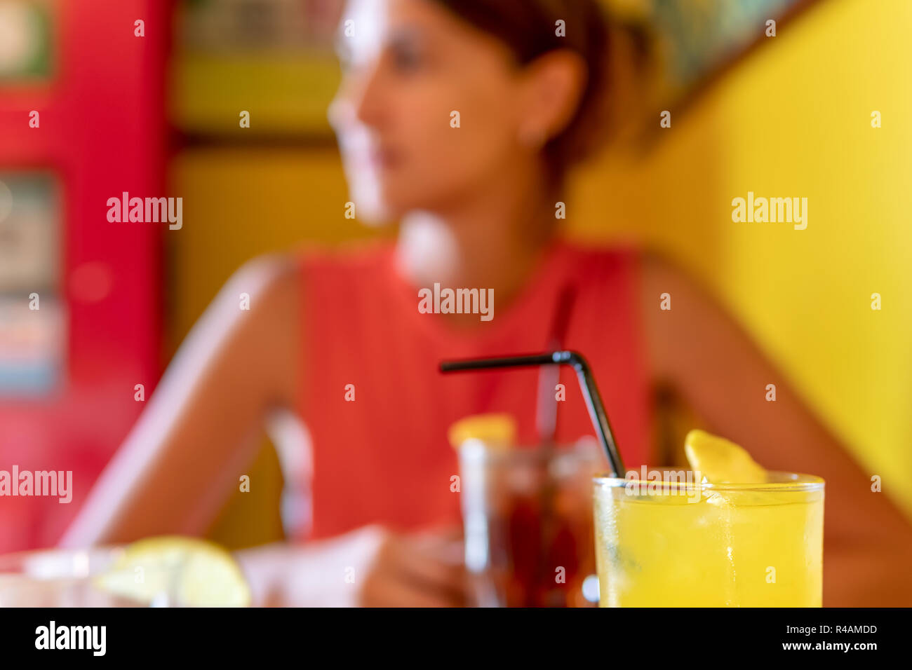 Young Woman Drinking Refreshments In Restaurant Stock Photo - Alamy