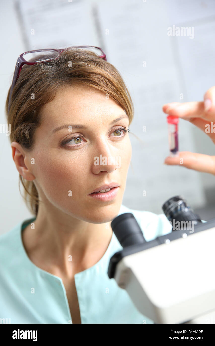 Biologist checking on blood sample Stock Photo - Alamy