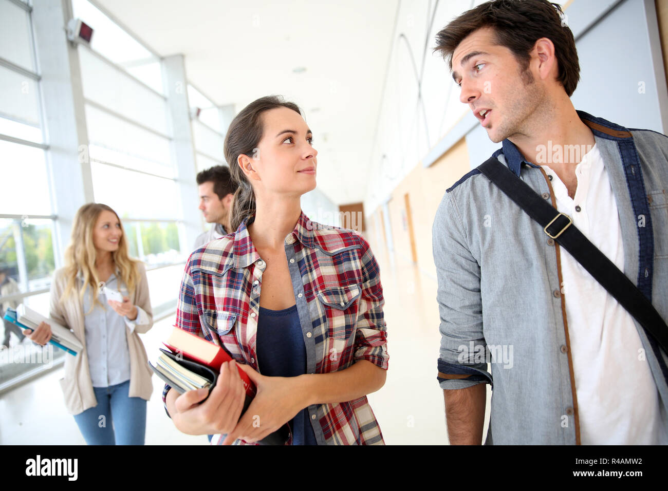 Student people walking in college hallway Stock Photo - Alamy