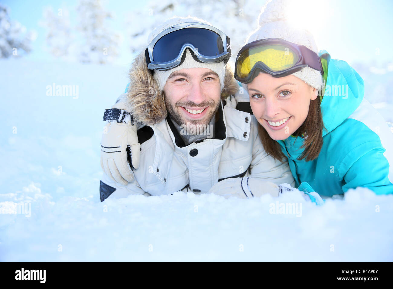 Portrait of loving couple of skiers in snowy moutain Stock Photo - Alamy