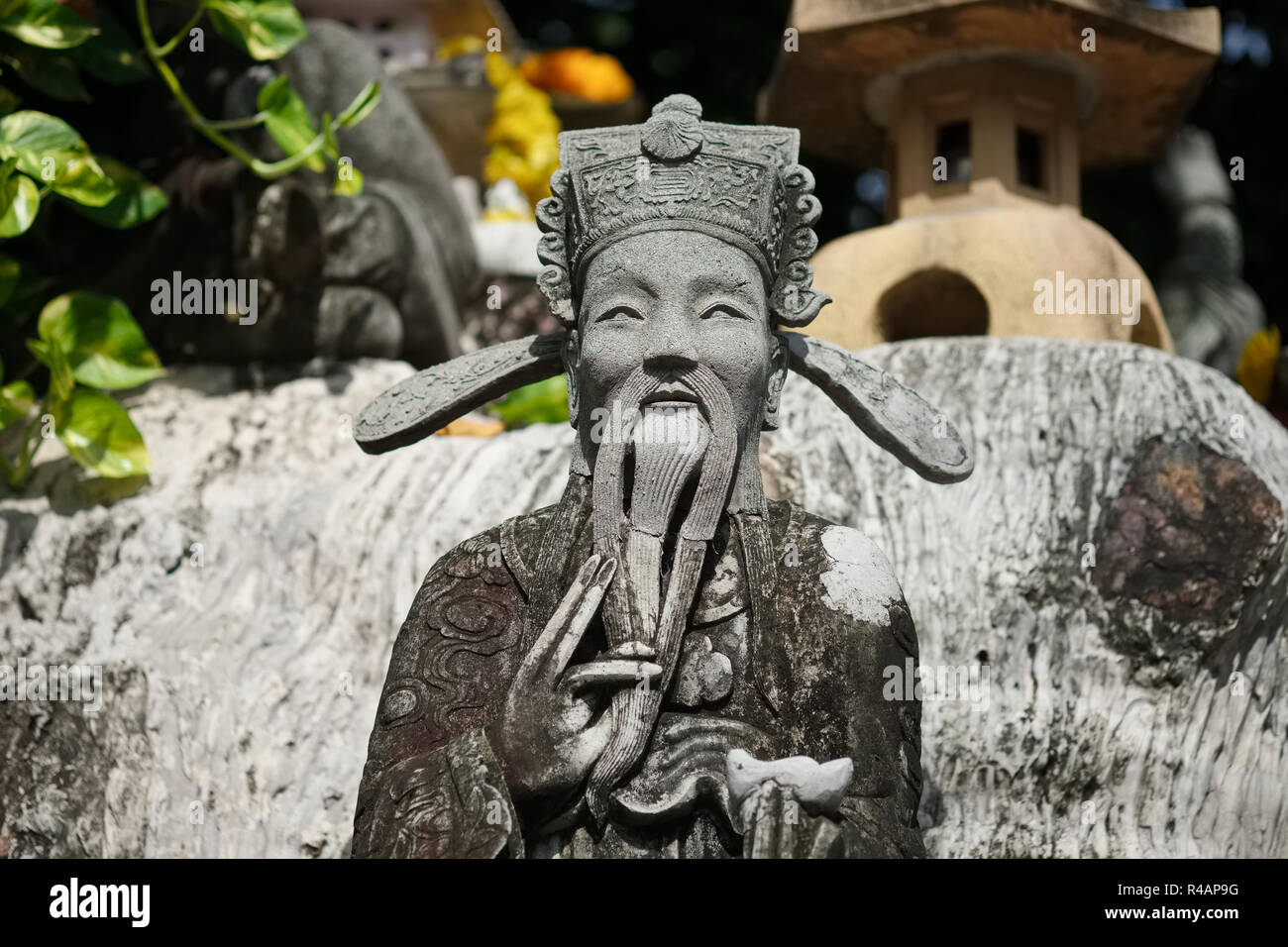 Statue of a wise Chinese man on the grounds of Wat Suthat, Bangkok ...