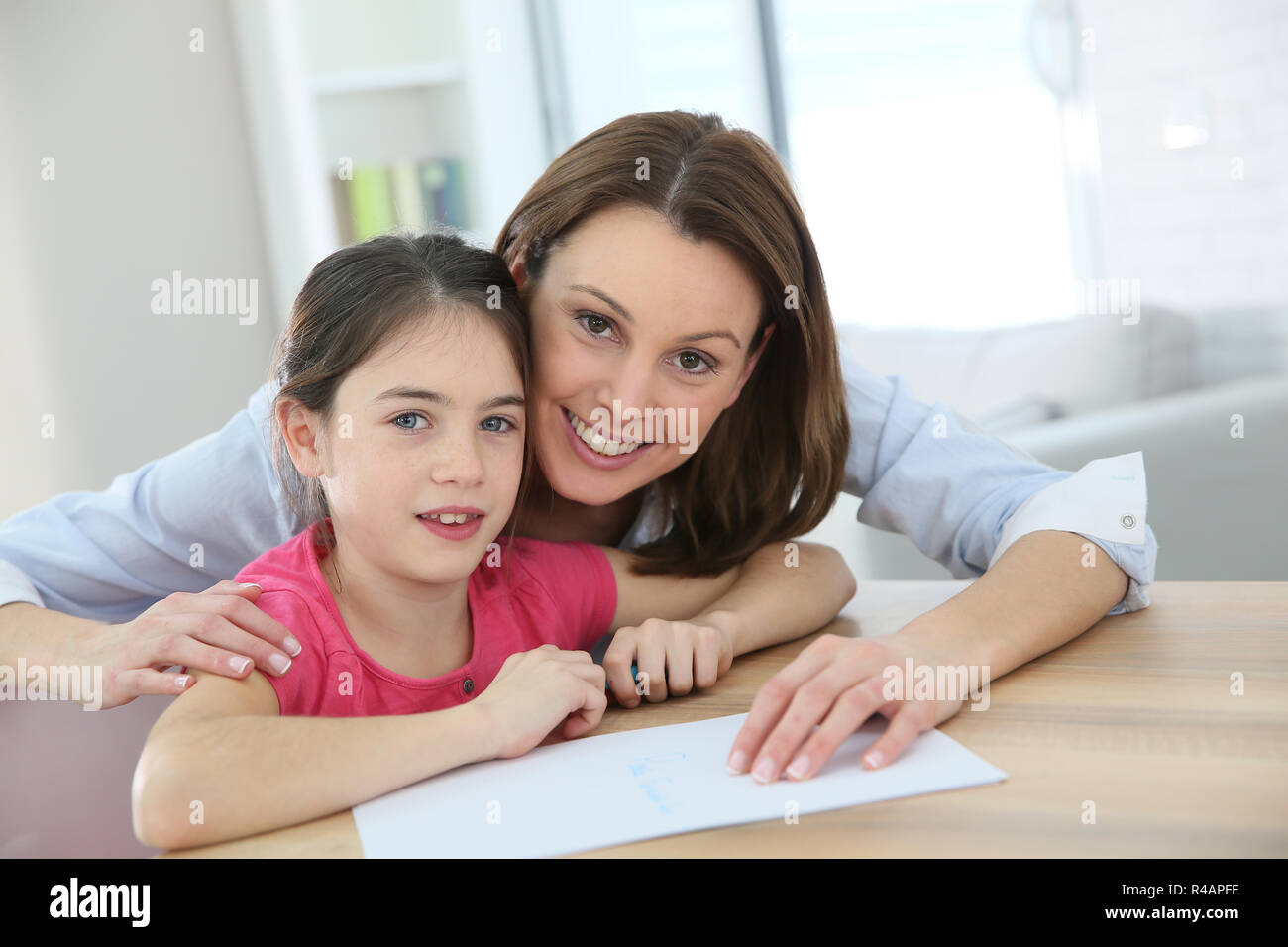 School girl with mother learning to write Stock Photo - Alamy