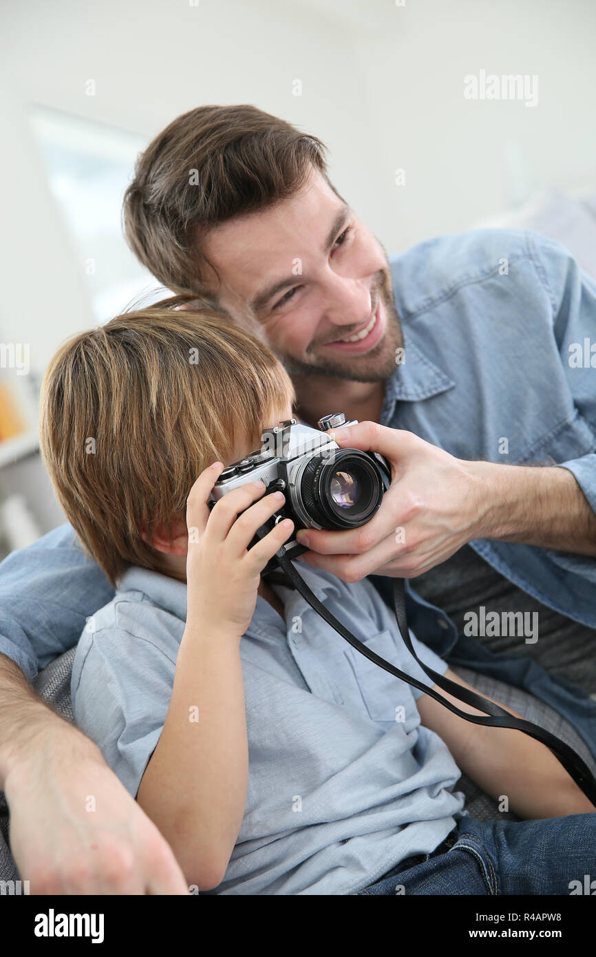 Daddy with son using photo camera Stock Photo - Alamy