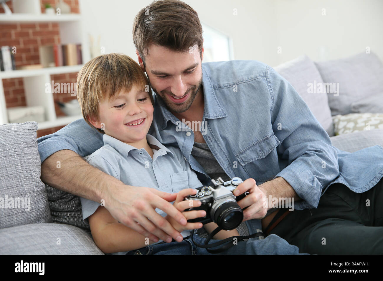 Daddy with son using photo camera Stock Photo - Alamy
