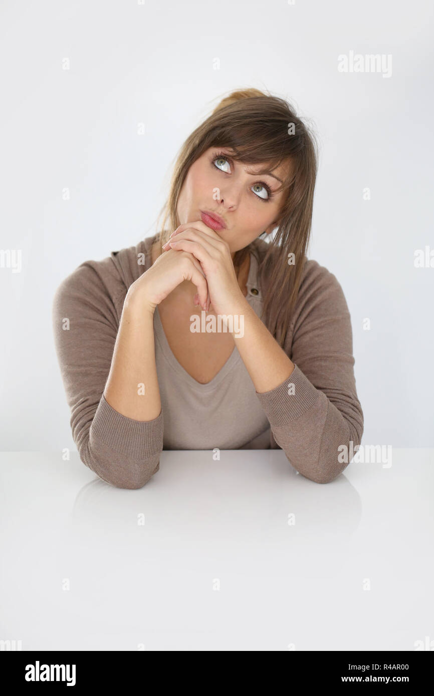 Young woman looking up and being thoughful, isolated Stock Photo - Alamy