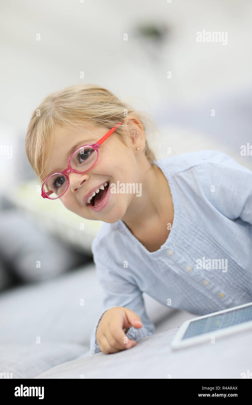 Cute little girl playing with digital tablet Stock Photo - Alamy