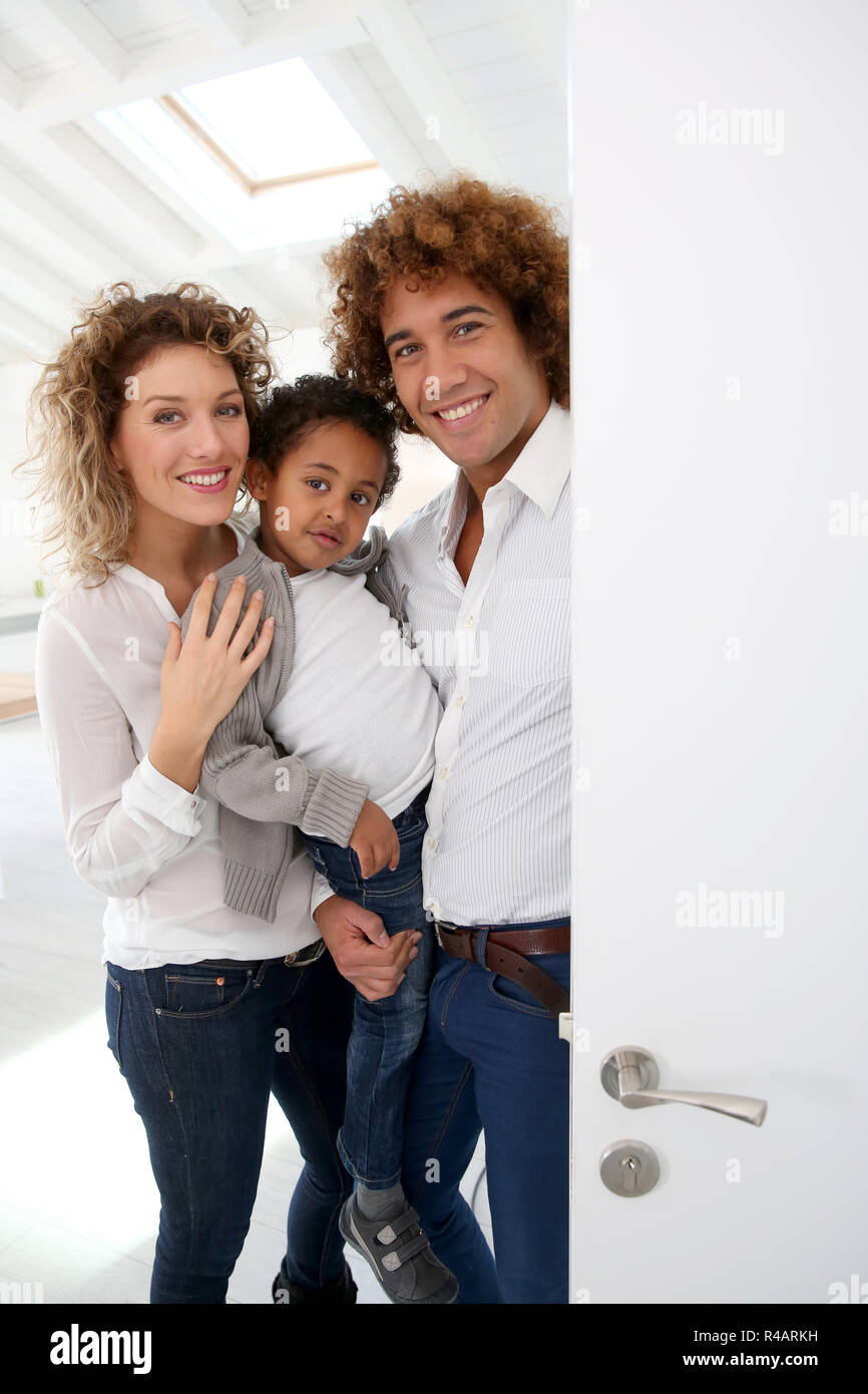 Happy family welcoming people in new home Stock Photo - Alamy