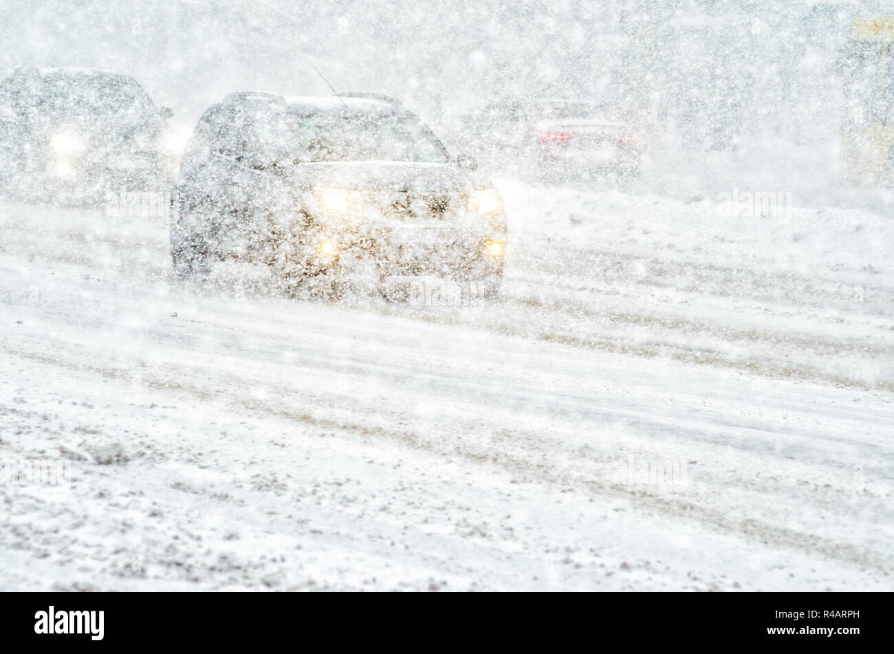 Car rides through a snowstorm. Limited vision on the road. Blizzard ...