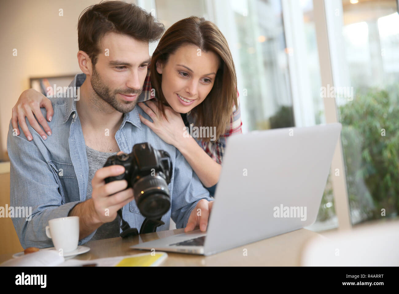 Couple watching photos on laptop computer Stock Photo - Alamy