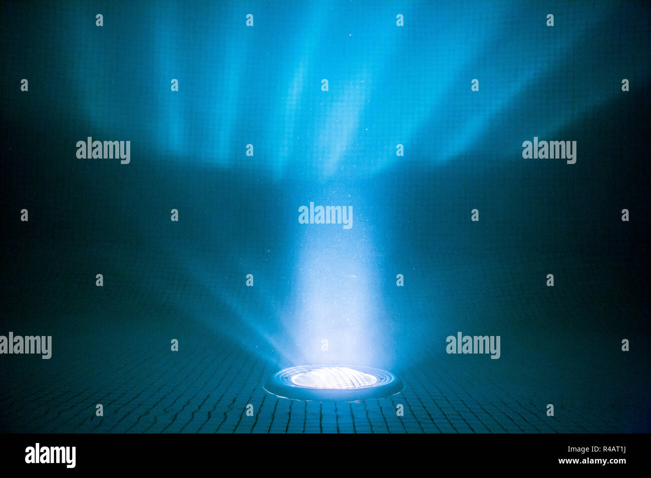 An outdoor pool at night liluminated by underwater lighting Stock Photo ...