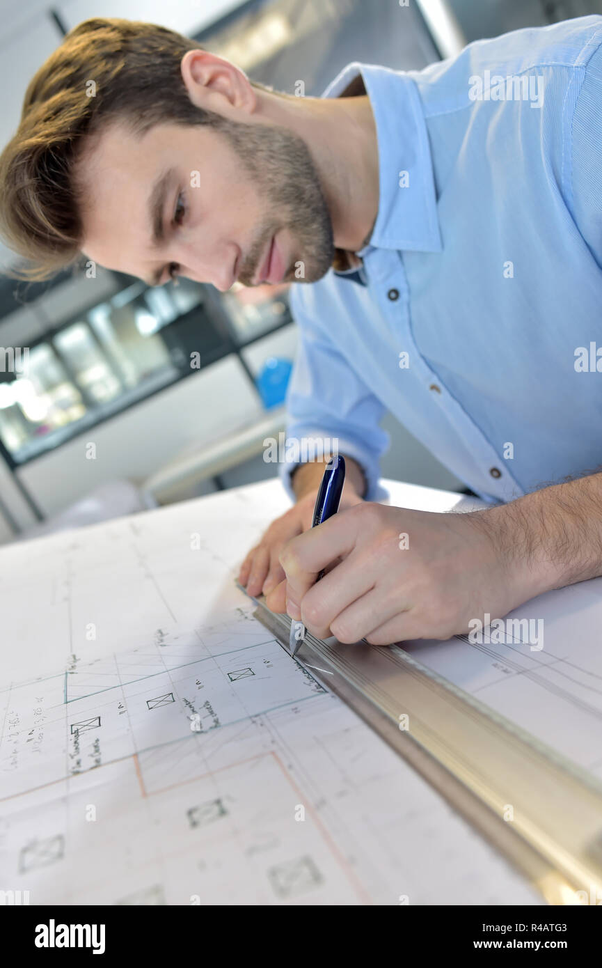 Architect designing on drafting table Stock Photo - Alamy