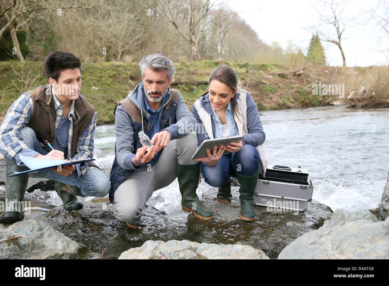 Biologist with students in science testing river water Stock Photo - Alamy