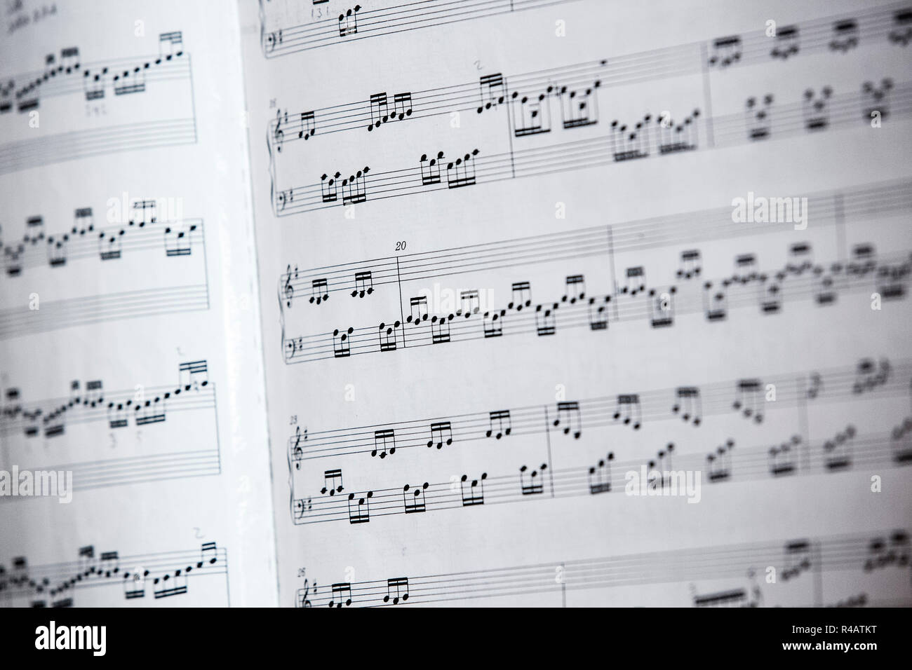 Musical notes on white paper music book Stock Photo - Alamy