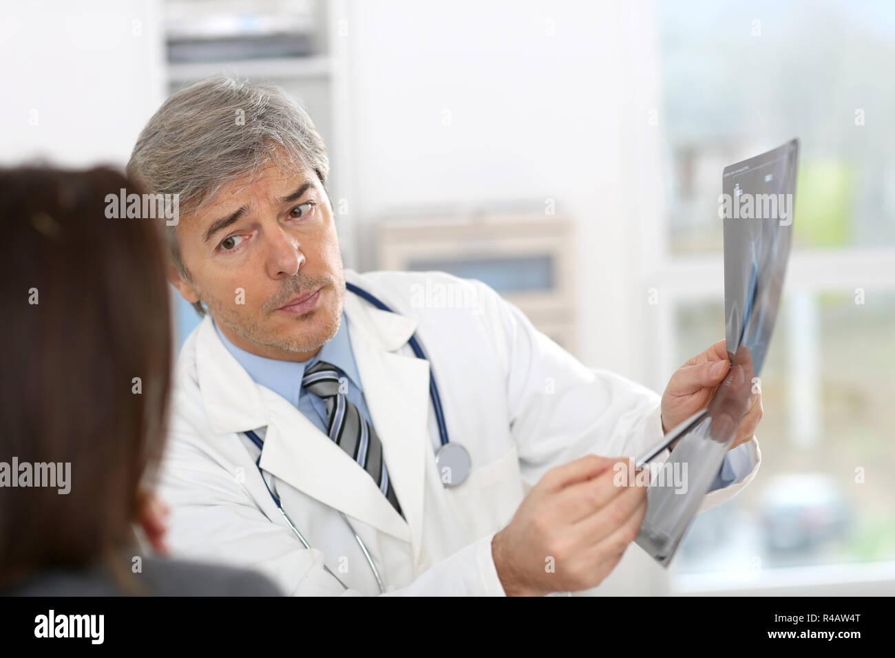 Attractive doctor showing radiography hi-res stock photography and ...