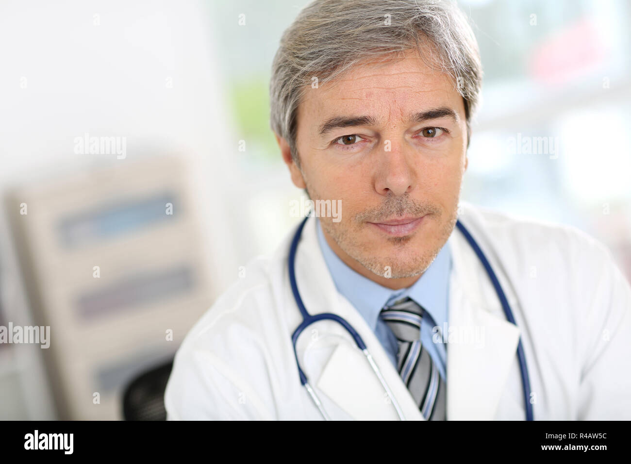 Portrait of attractive senior doctor Stock Photo - Alamy