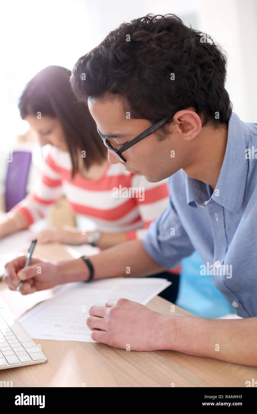 Student filling application form for business school Stock Photo - Alamy